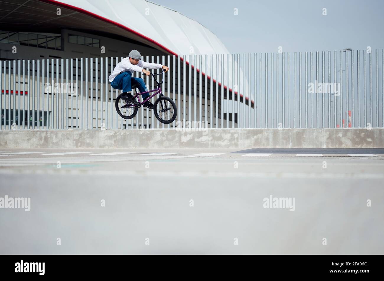 Young man jumping mid air with his bike Stock Photo - Alamy