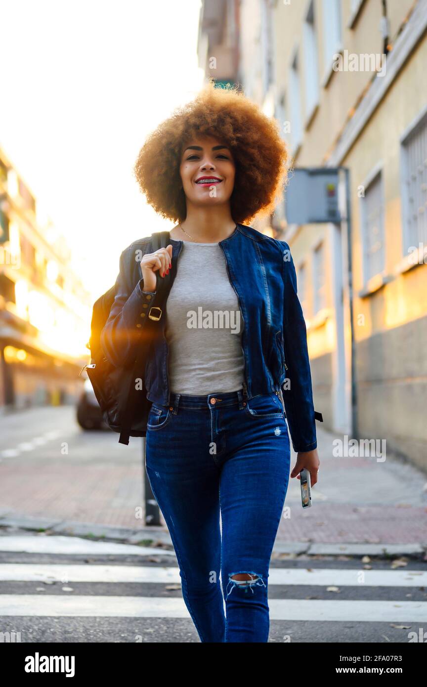 beautiful young woman crossing street Stock Photo - Alamy