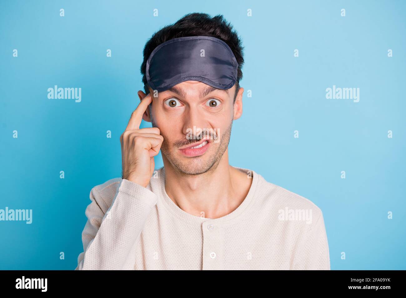 Portrait of nice funny confused guy wearing sleep mask oops mistake ...