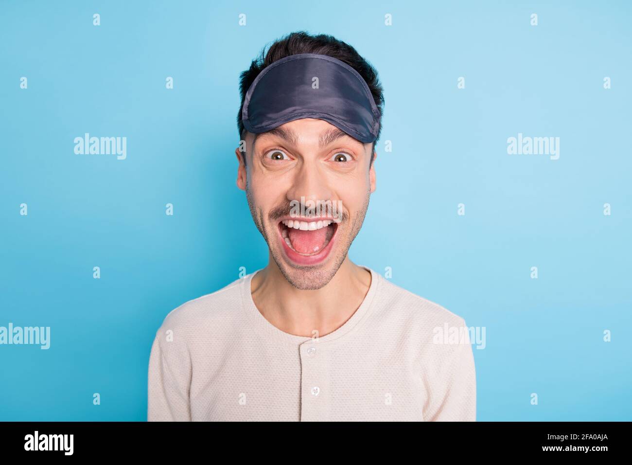 Portrait of nice cheerful emotional brunet guy wearing sleep mask ...