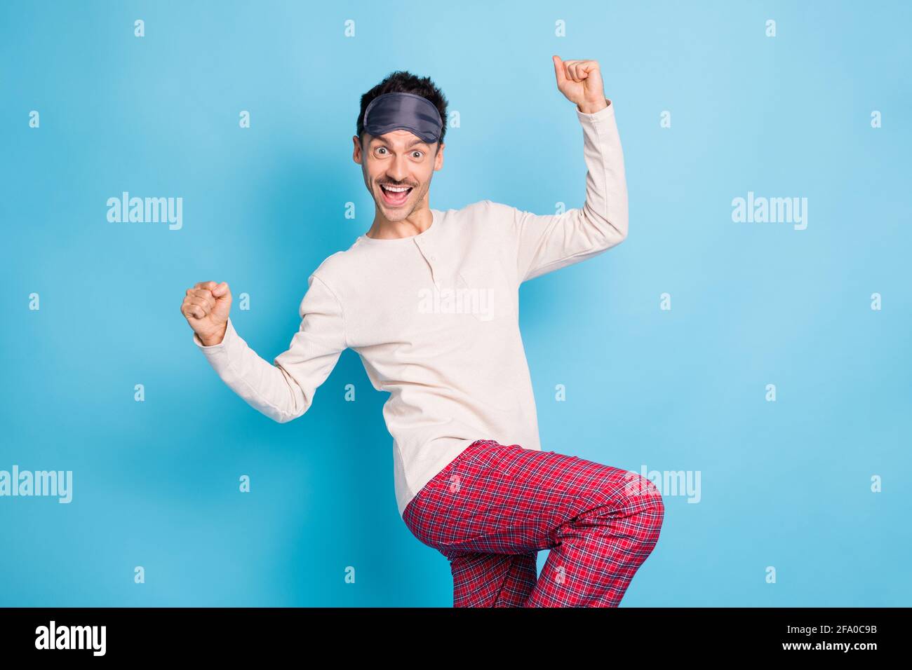 Portrait of nice cheerful guy wearing sleep clothes dancing rejoicing ...