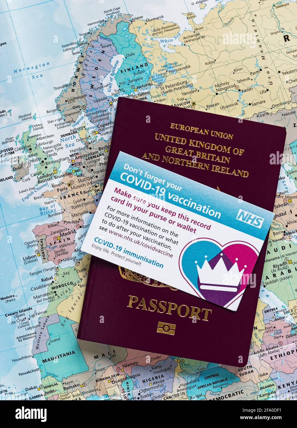 Pfizer vaccine card with passport on world map Stock Photo - Alamy
