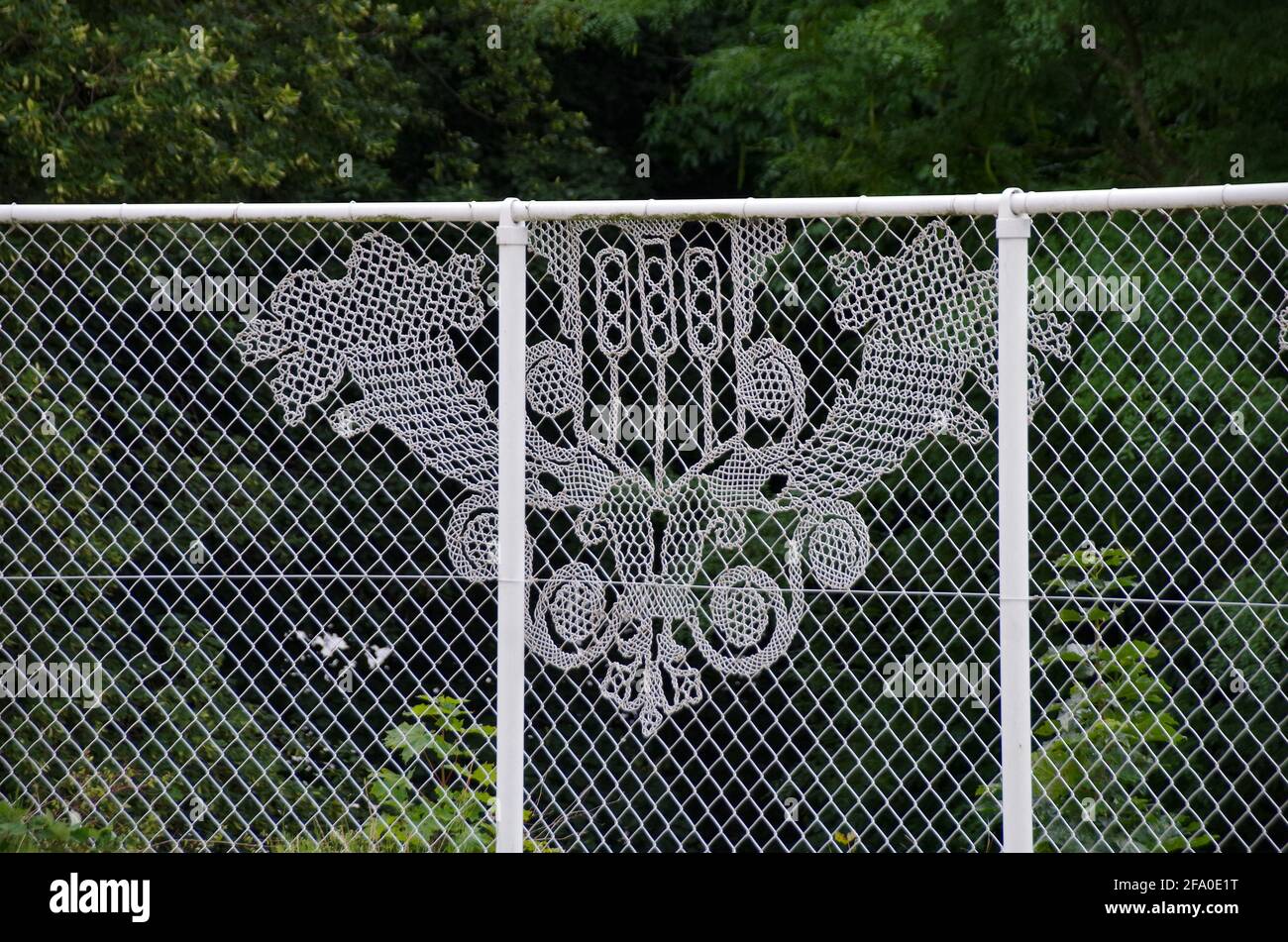 White Crochet in a fence Stock Photo - Alamy