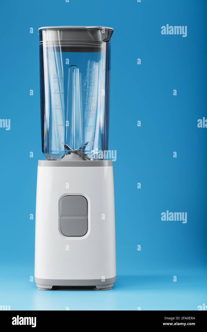 Electric blender with an empty cup on a blue background. Free space ...