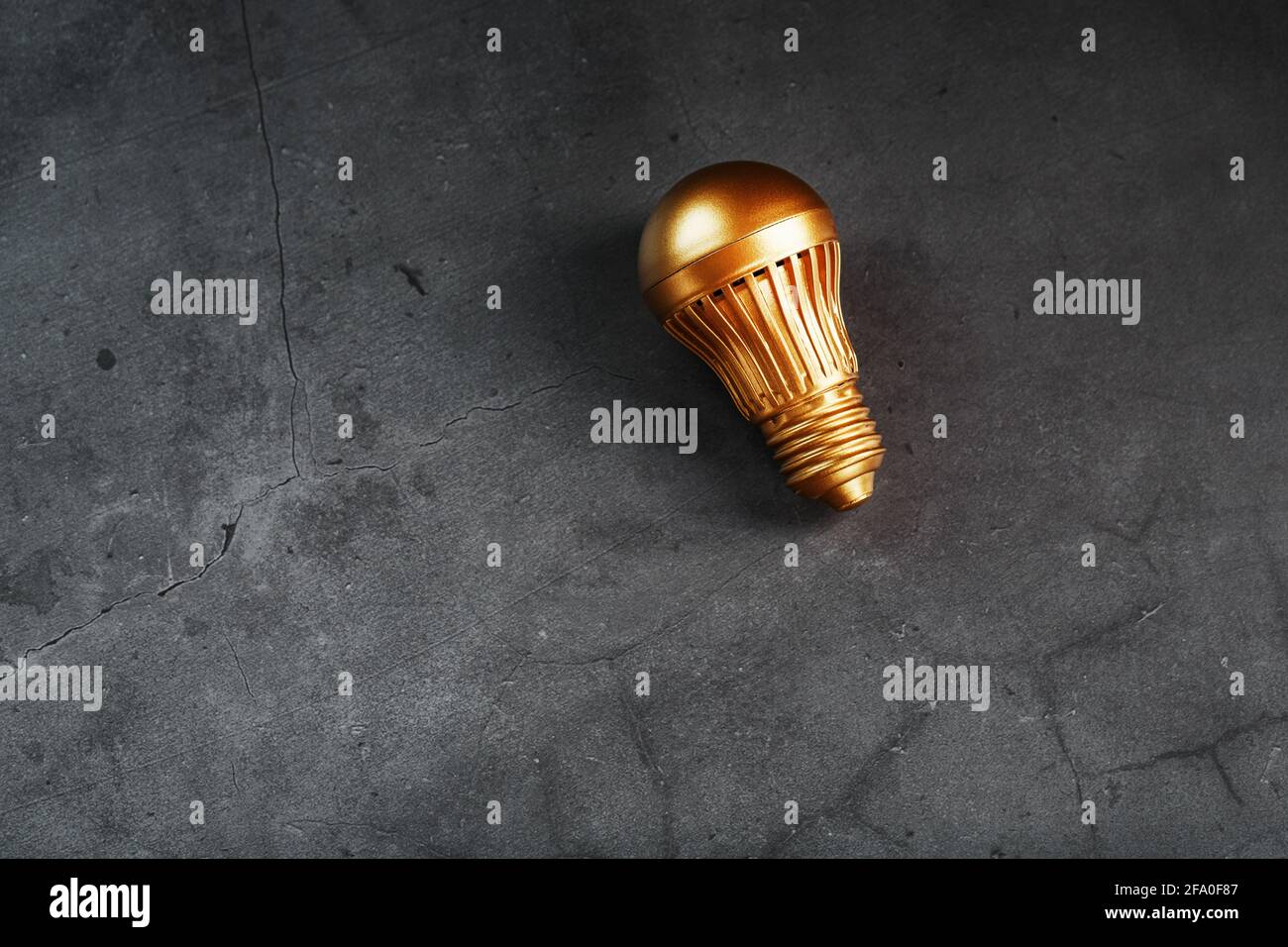 Light bulb from gold on black stone concept of a profitable idea. Top ...