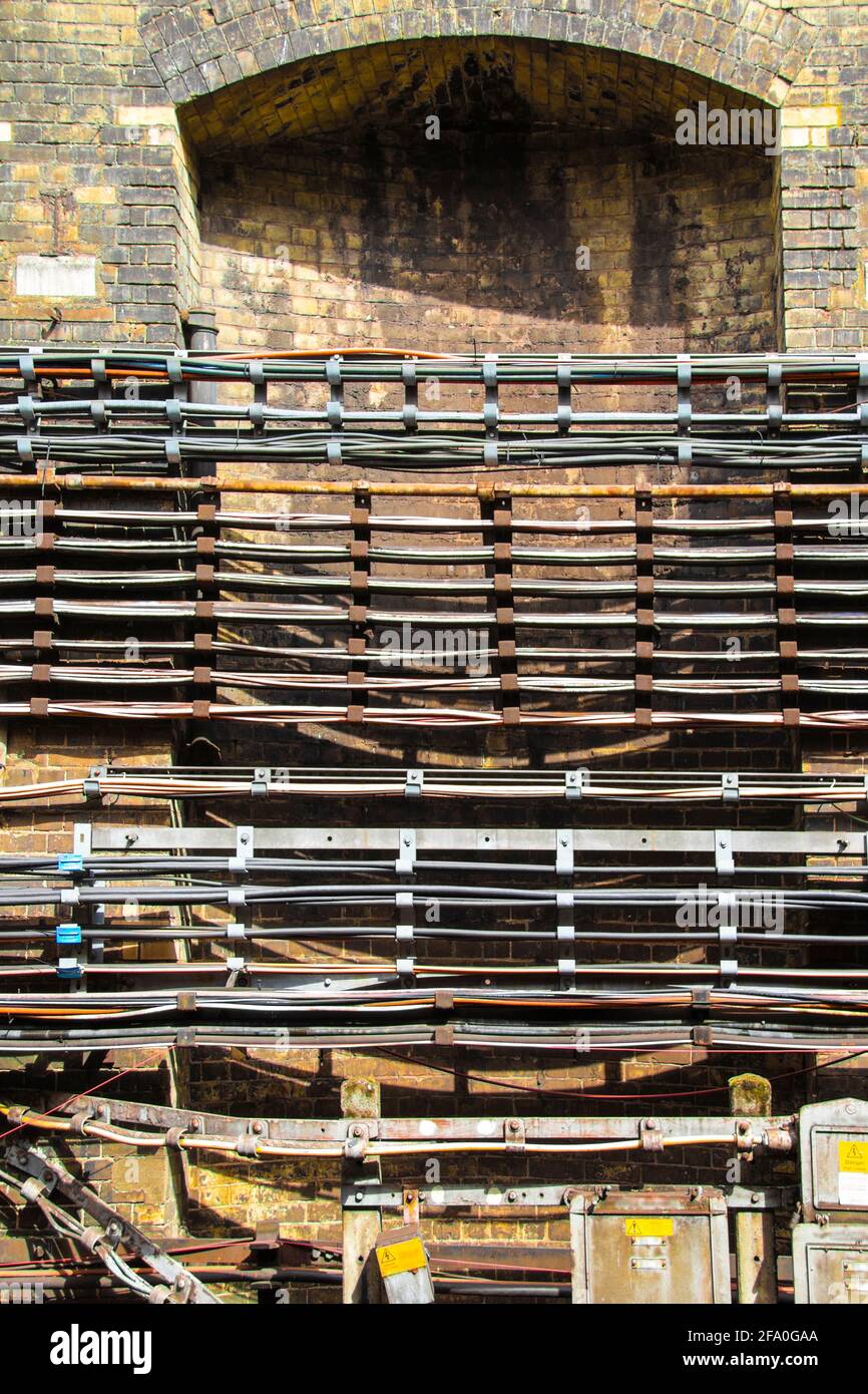 Cables fastened along wall underground in London subway Stock Photo - Alamy