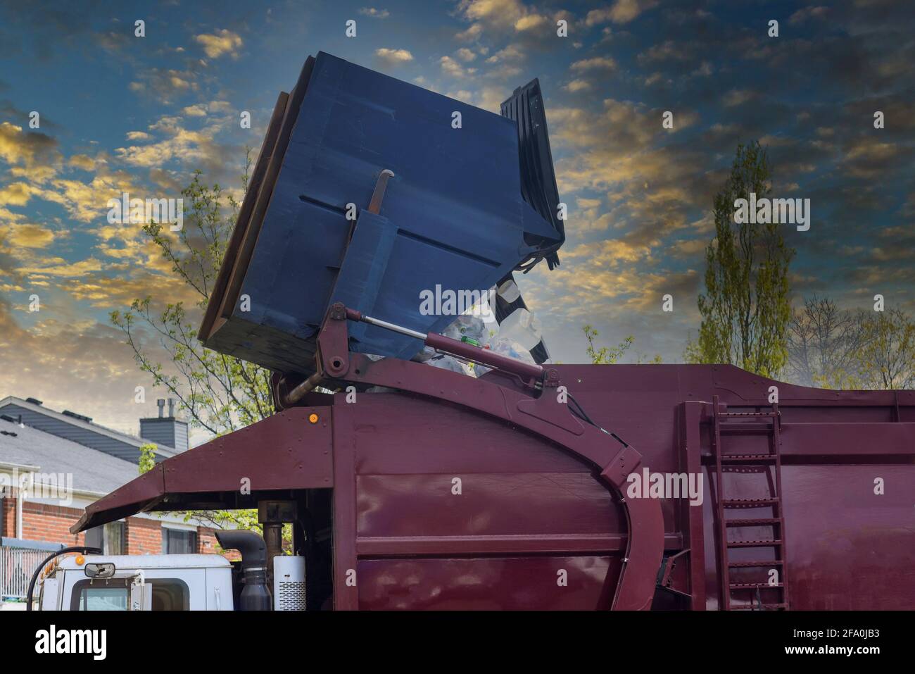 Lorry truck loading a skip waste management container Stock Photo - Alamy