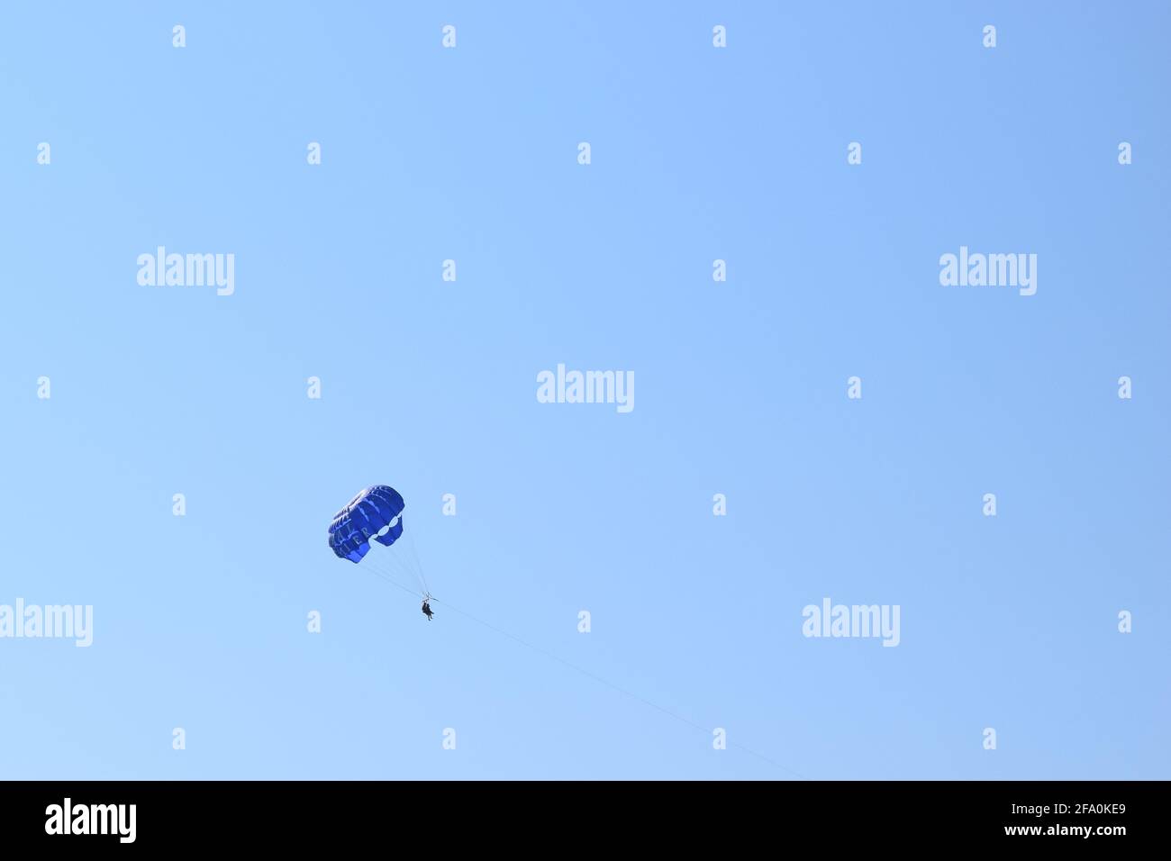 Recreational parakiting background - silhouetes of three people under ...