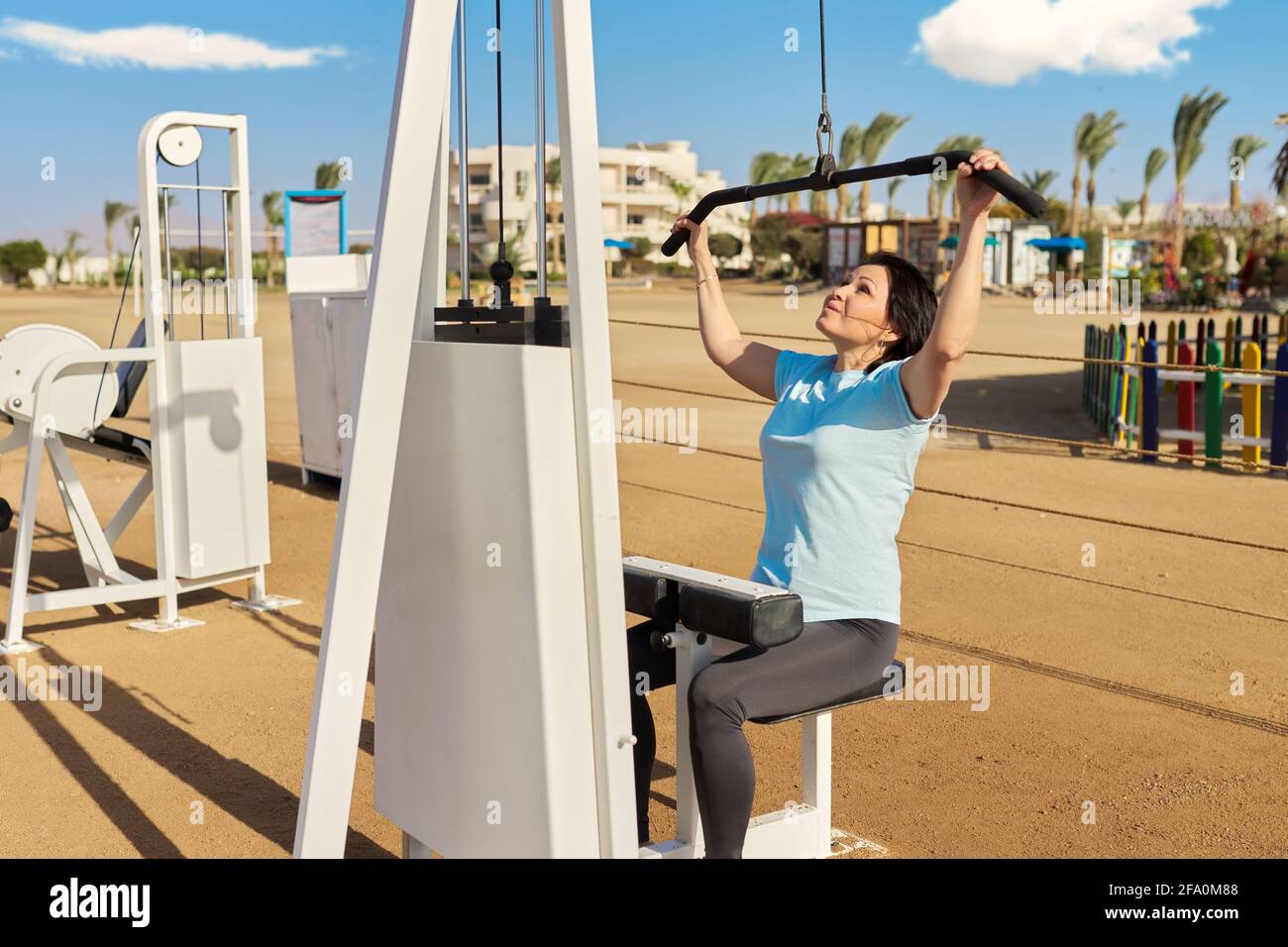 Mature woman doing sports exercises on outdoor simulators Stock Photo ...