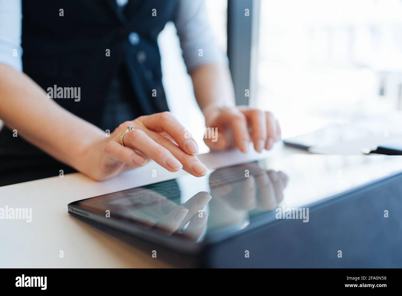 Woman fingers typing on tablet screen . Using technologies concept ...