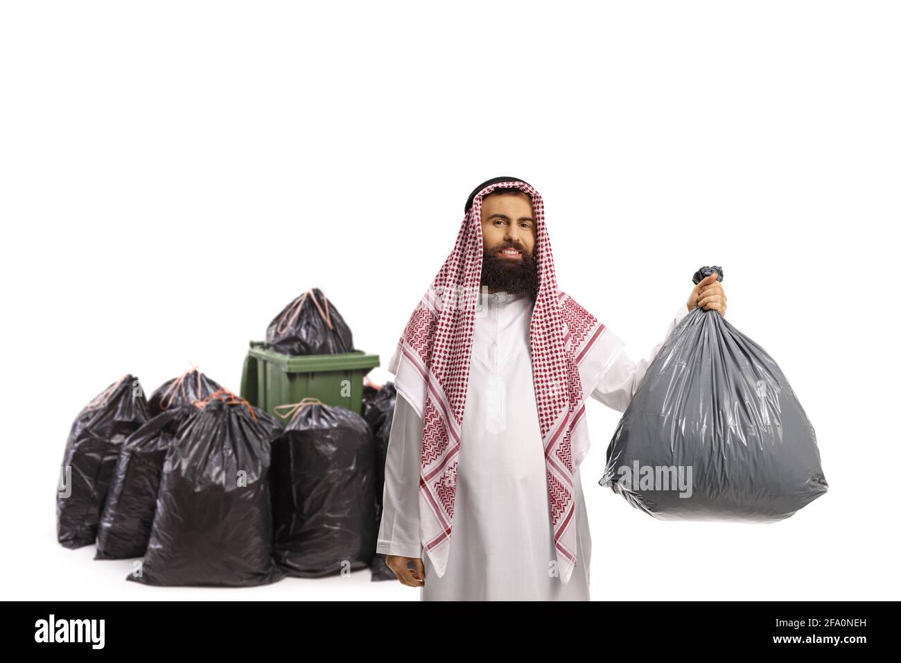 Saudi arab man throwing a plastic waste bag in a bin isolated on white ...