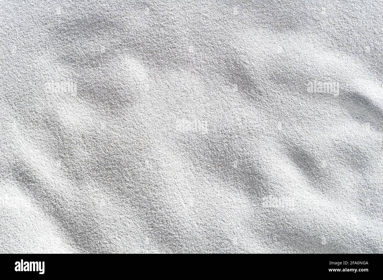 A flat background of coarse ground pumice, lit to show maximum texture ...