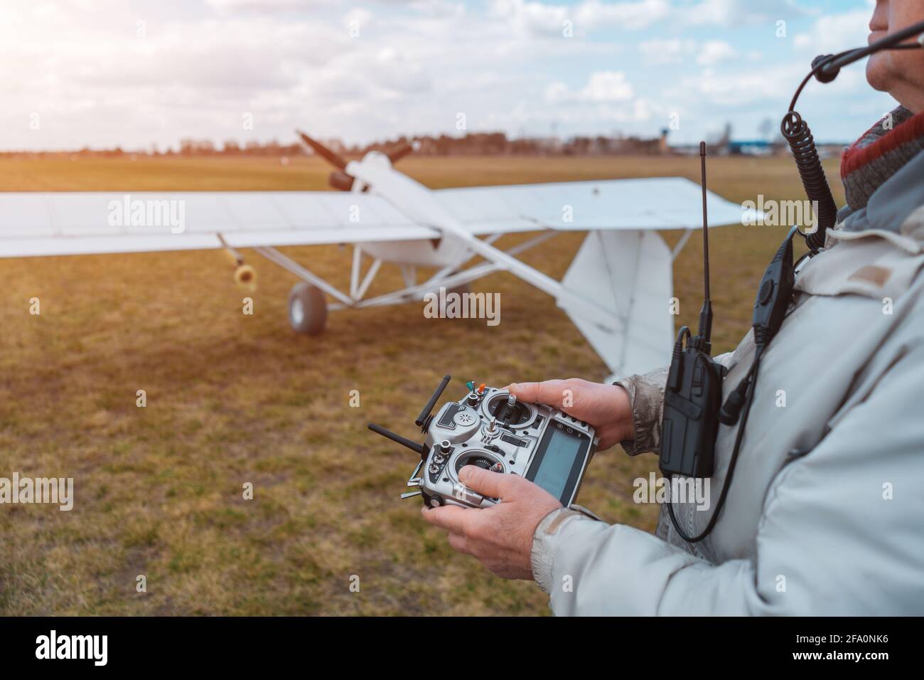close up pilot hand with remote control joystick for agricultural ...