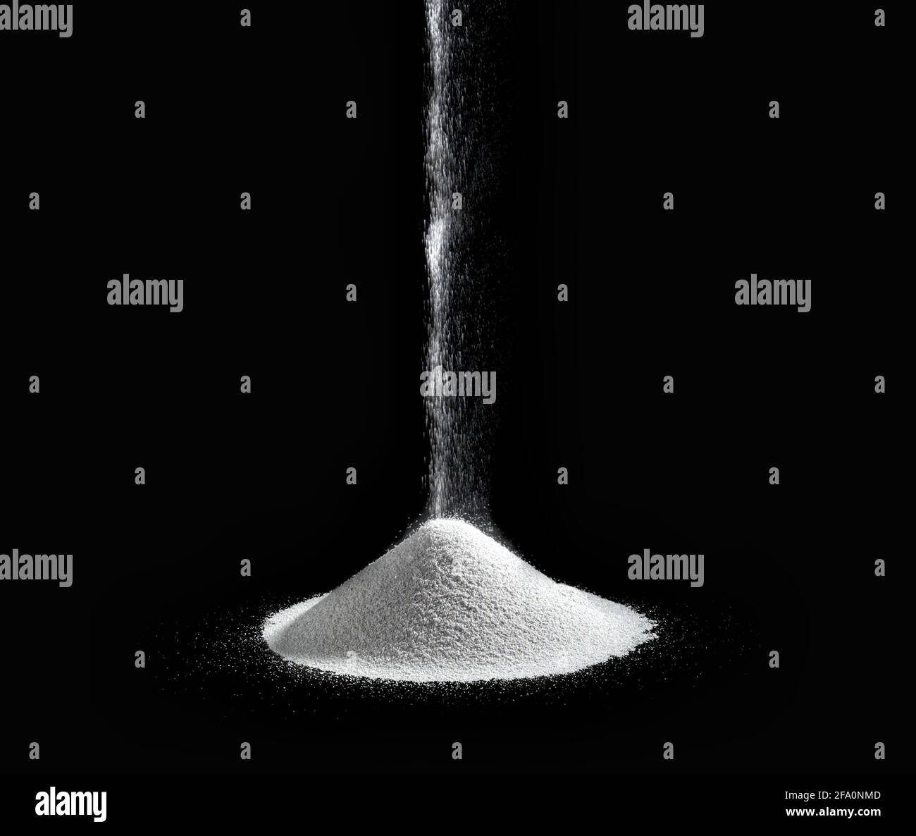 Coarse ground pumice, lit to show maximum texture, falling into a pile ...