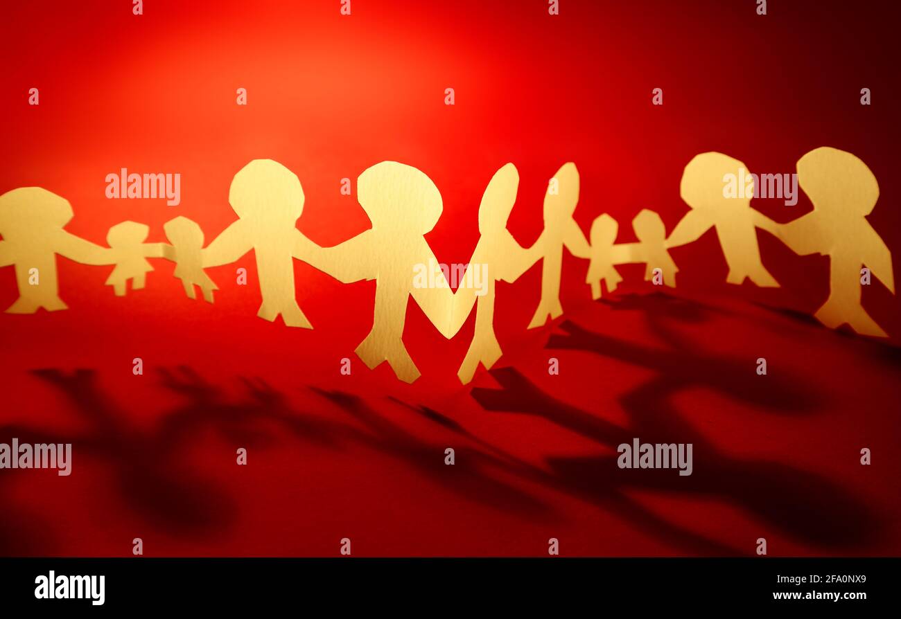 Paper chain team holding hands. Teamwork. Partnership Stock Photo - Alamy