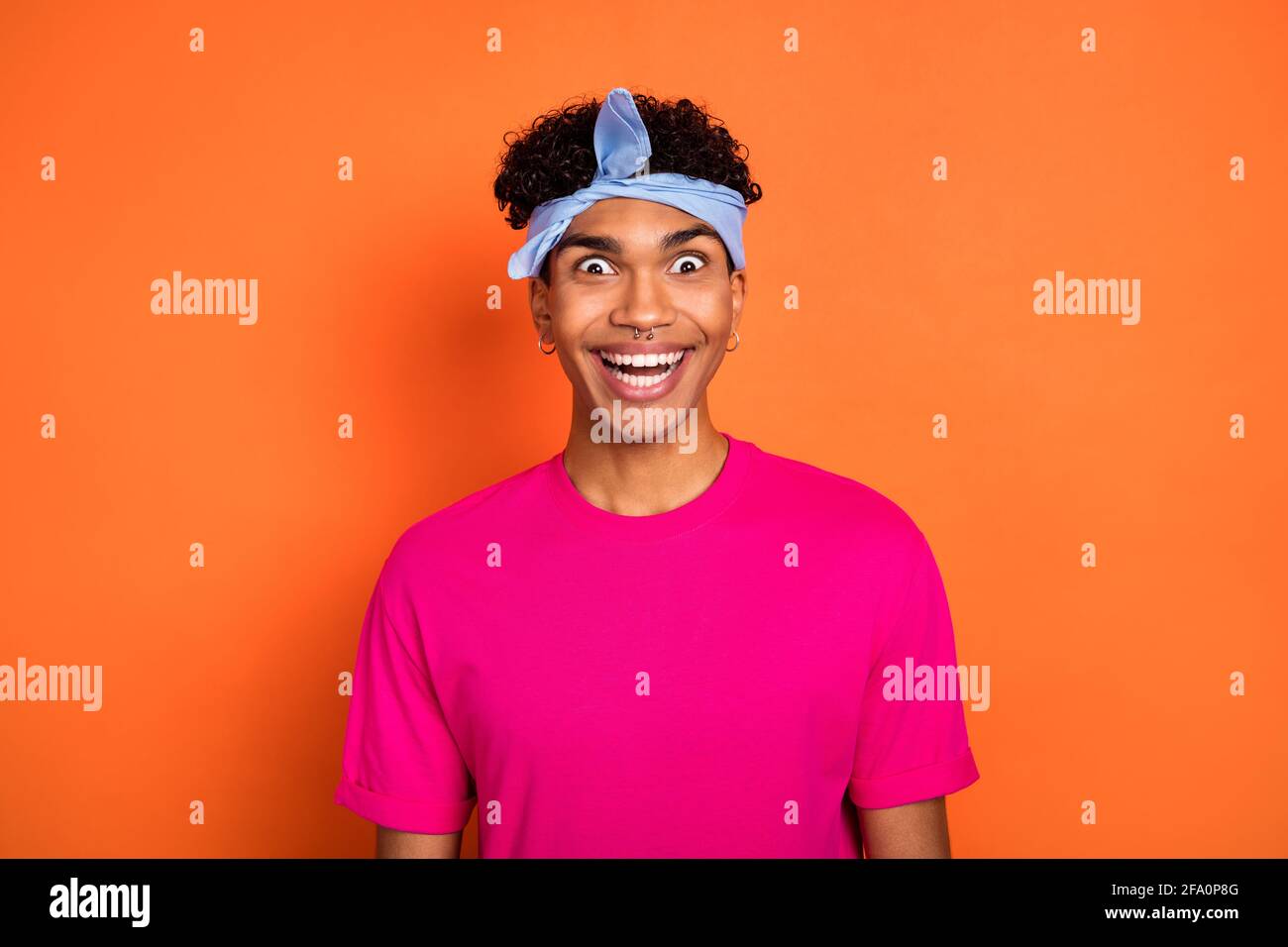 Photo portrait of smiling crazy guy wearing headband piercing staring ...