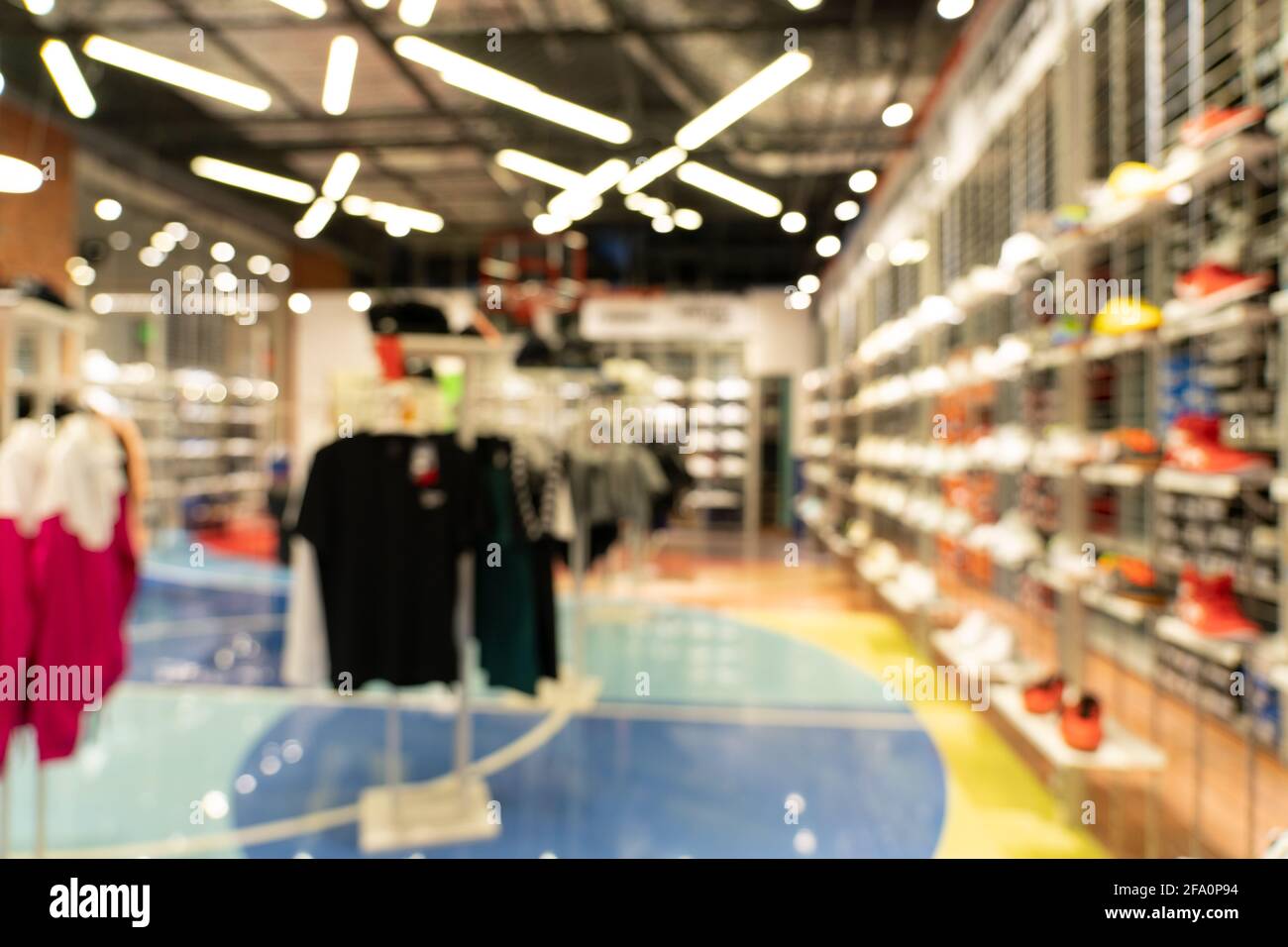 Abstract blur sport shoes and clothes on shelves in sports equipment ...