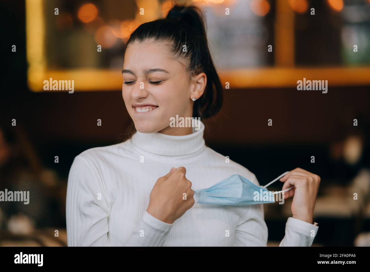 Girl takes off mask hi-res stock photography and images - Alamy