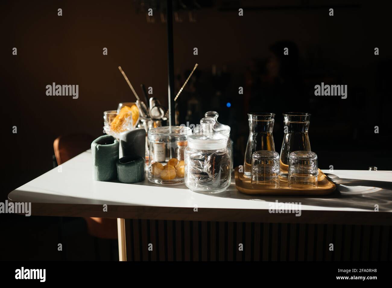Four glass cups on the bar counter with serving accessories Stock Photo ...