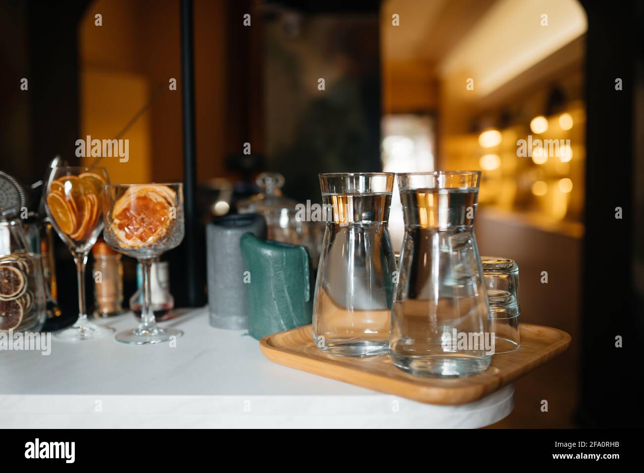 Four glass cups on the bar counter with serving accessories Stock Photo ...