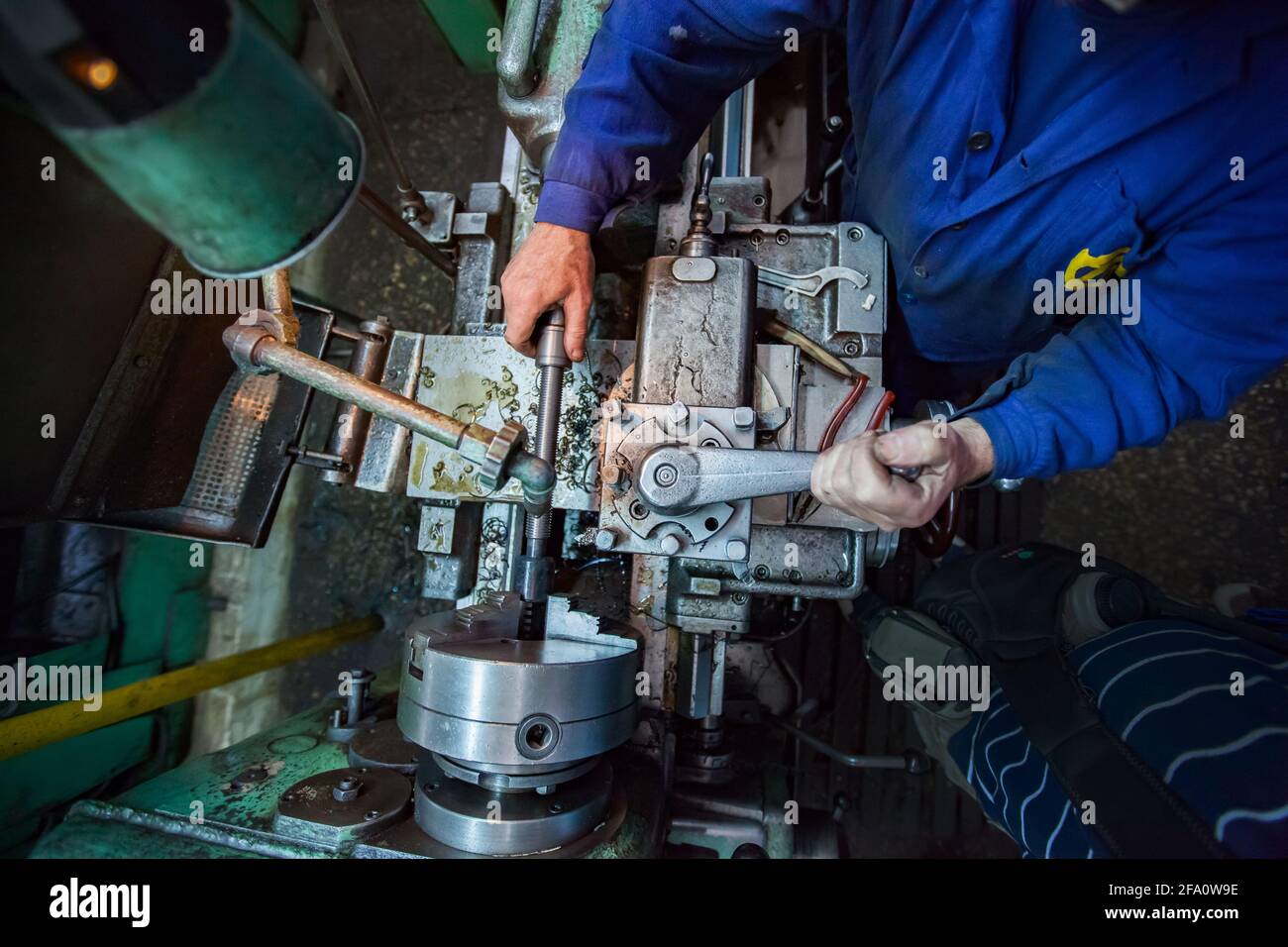 Heavy engineering plant. Lathe operator worker's hands and machine ...