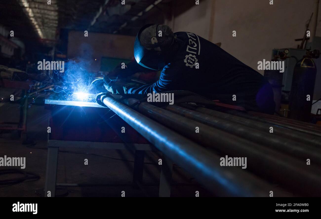 Heavy engineering plant. Welder weld metal pipes. Production of heat ...