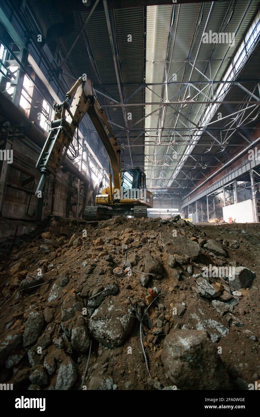 Workshop renovation. Excavator groundworks. Destruction of old ...