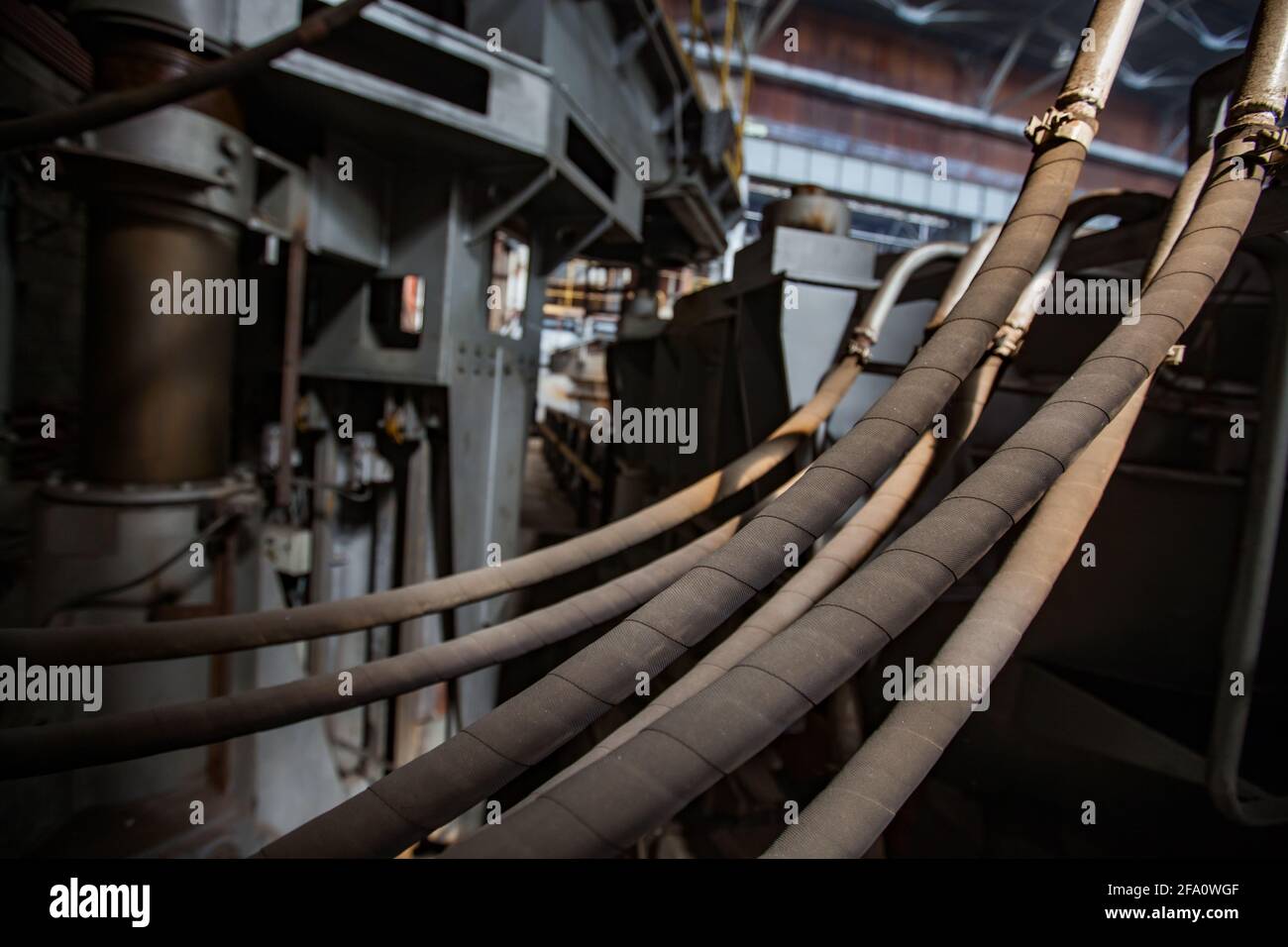 Close up of dirty and dusty protected electric power cables of machine ...
