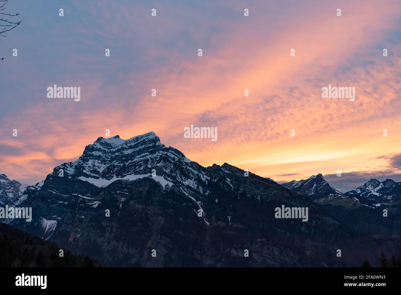 colorful sunset with mountains in swiss alps Stock Photo - Alamy