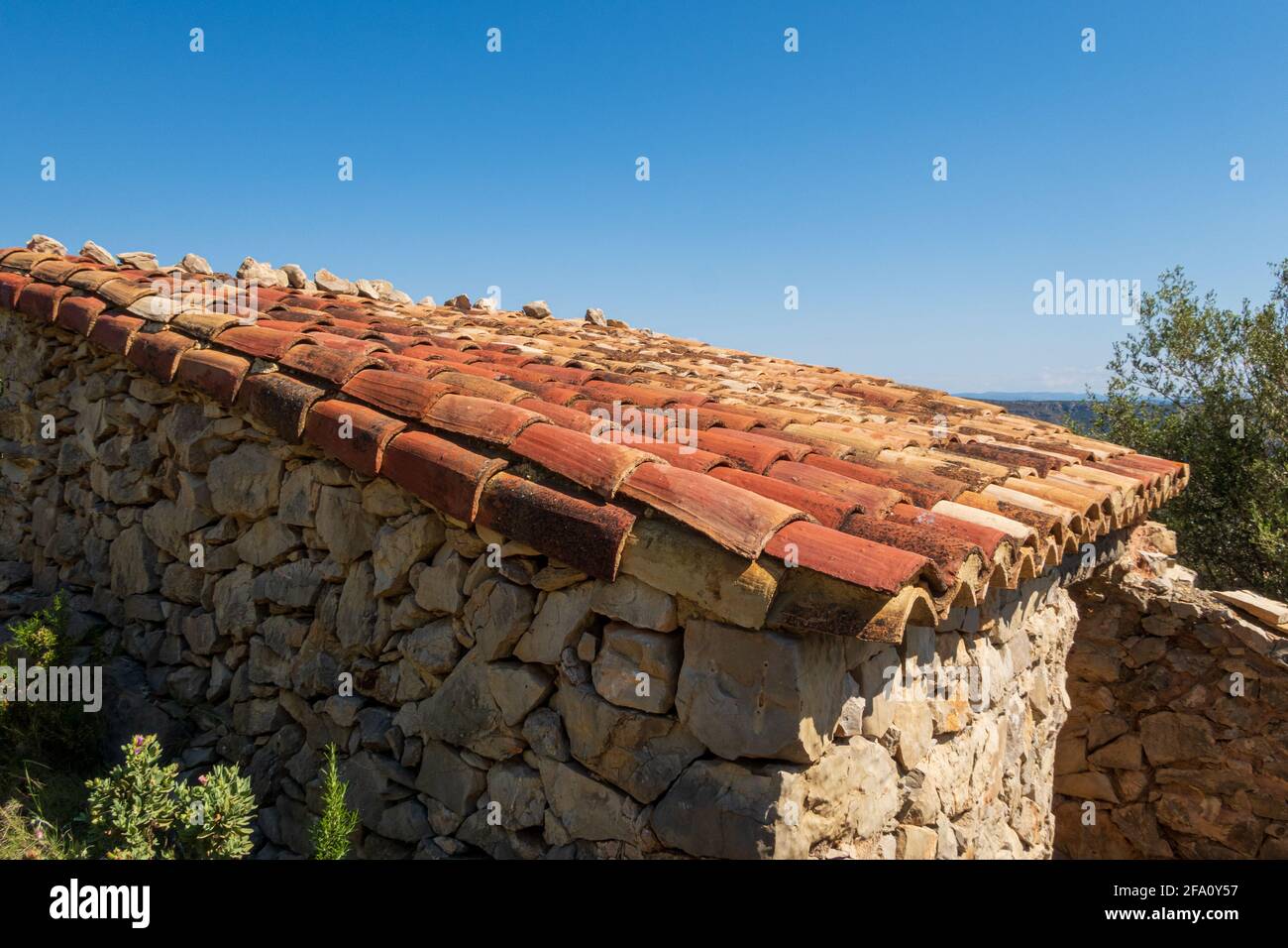 Sloping red tiled roof on a small house made of bricks Stock Photo - Alamy