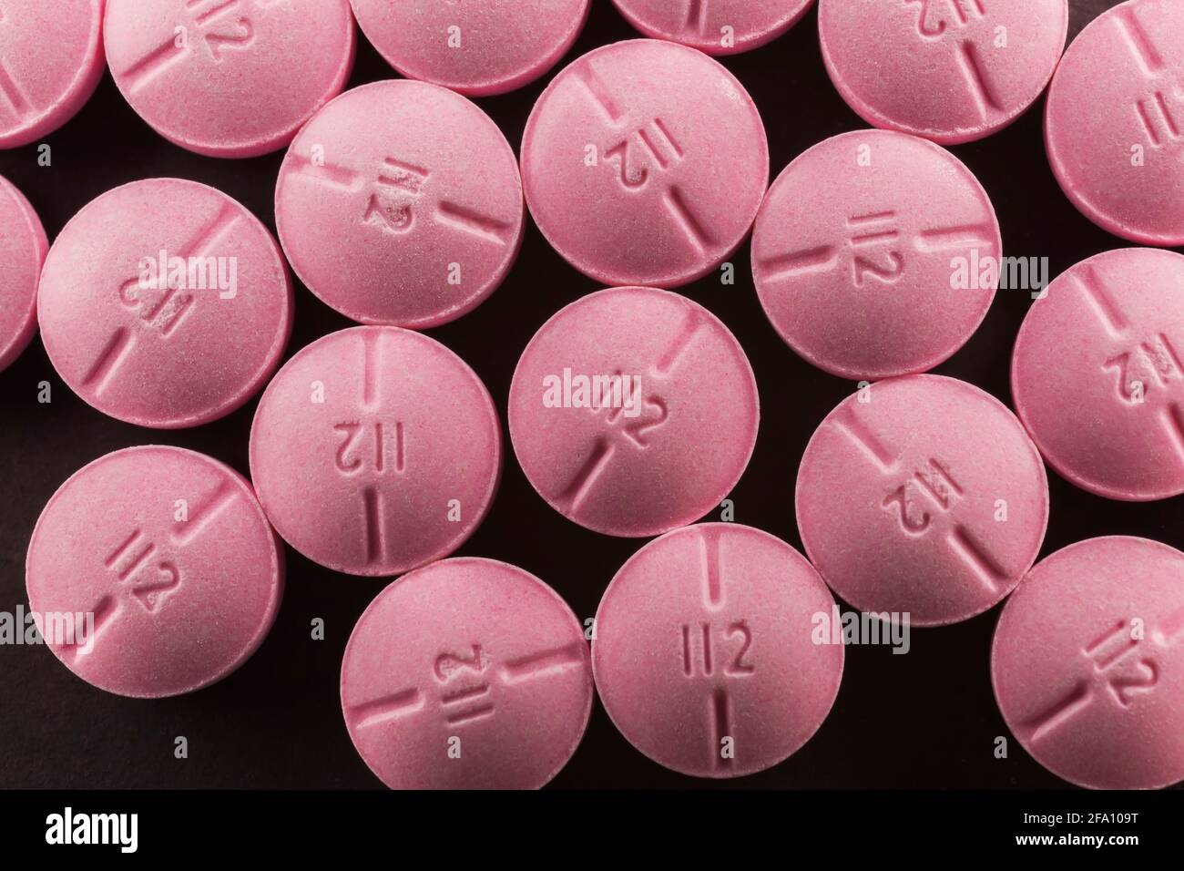 Pink medicine pills on black background Stock Photo - Alamy