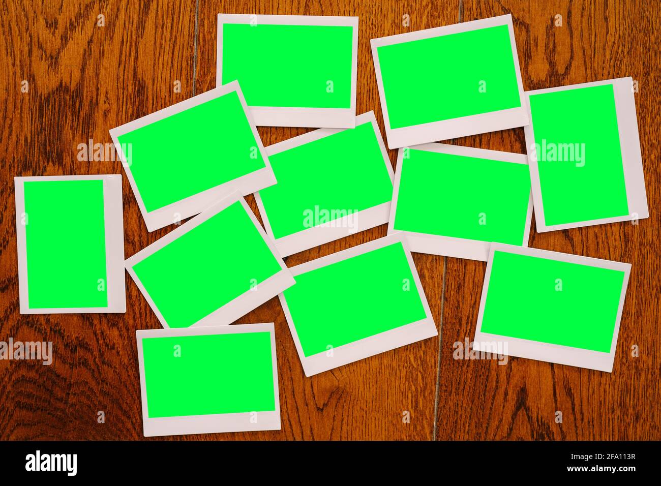 Many blank photographs lie on a wooden table Stock Photo - Alamy