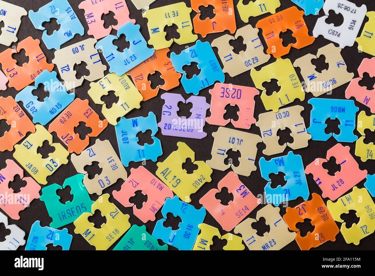 Colorful plastic bread clips on black background Stock Photo - Alamy