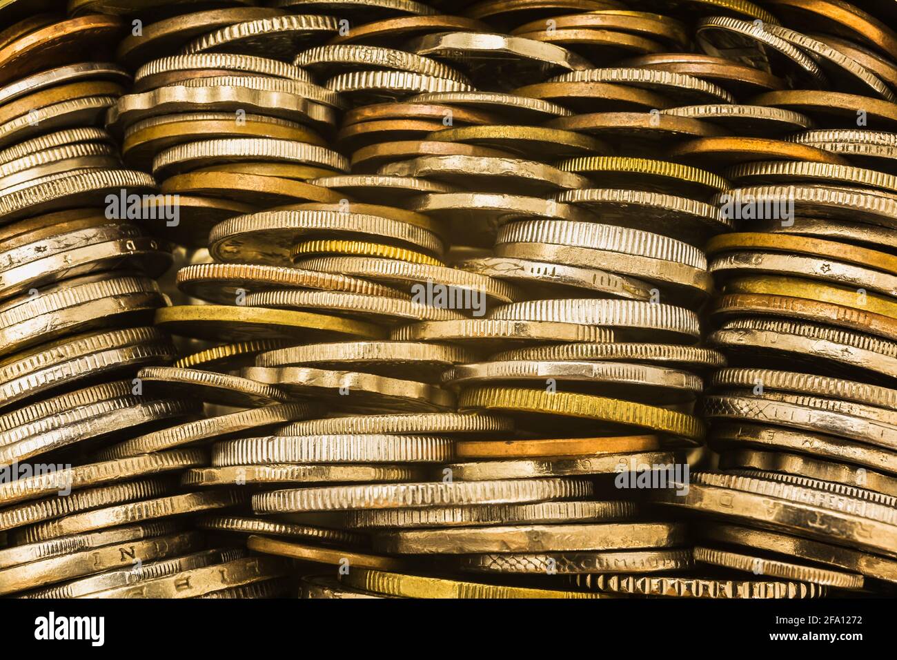 Silver, gold and copper metal foreign coins stacked in rows Stock Photo ...