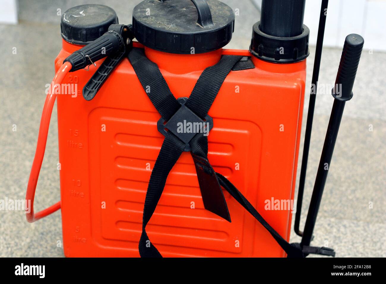 A side view of a back support disinfection sprayer container that ...