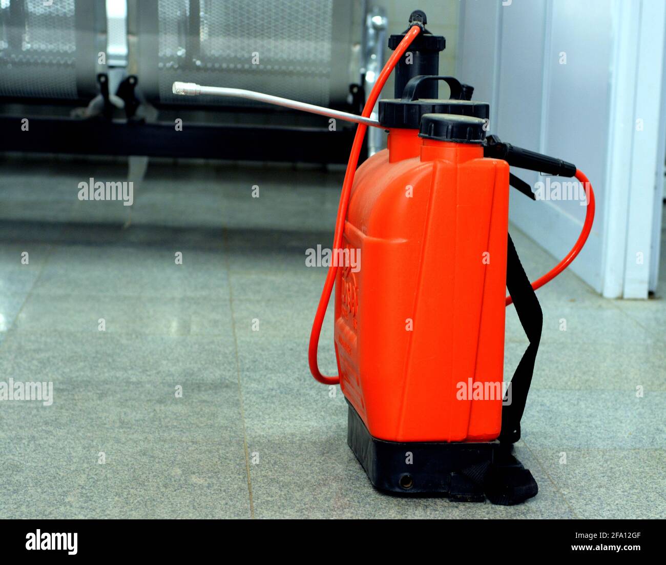 A side view of a back support disinfection sprayer container that ...