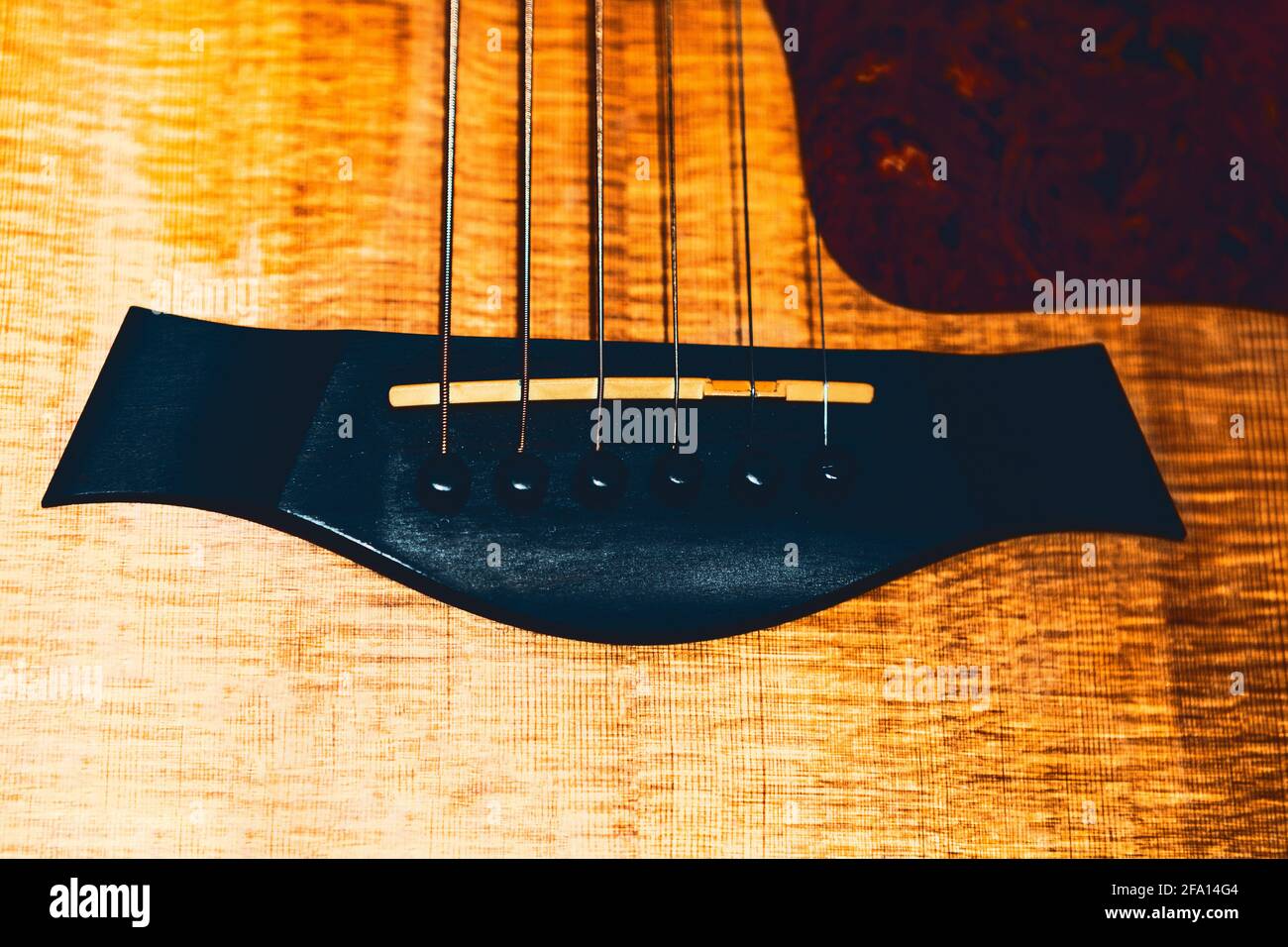 Wooden bridge of acoustic guitar with strings and pins Stock Photo - Alamy