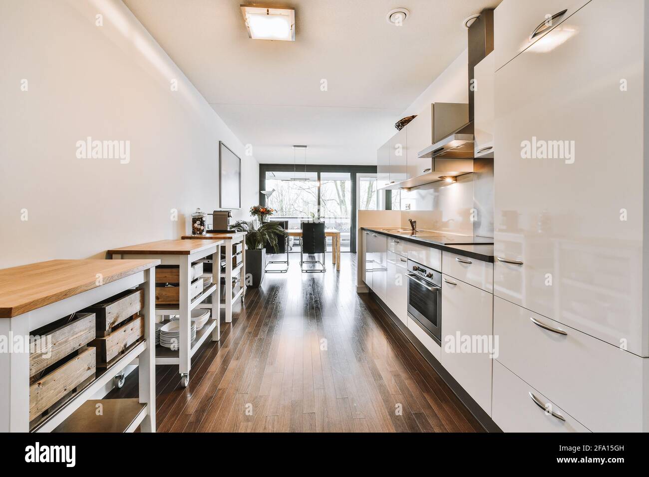 Modern kitchen near dining room in flat Stock Photo - Alamy