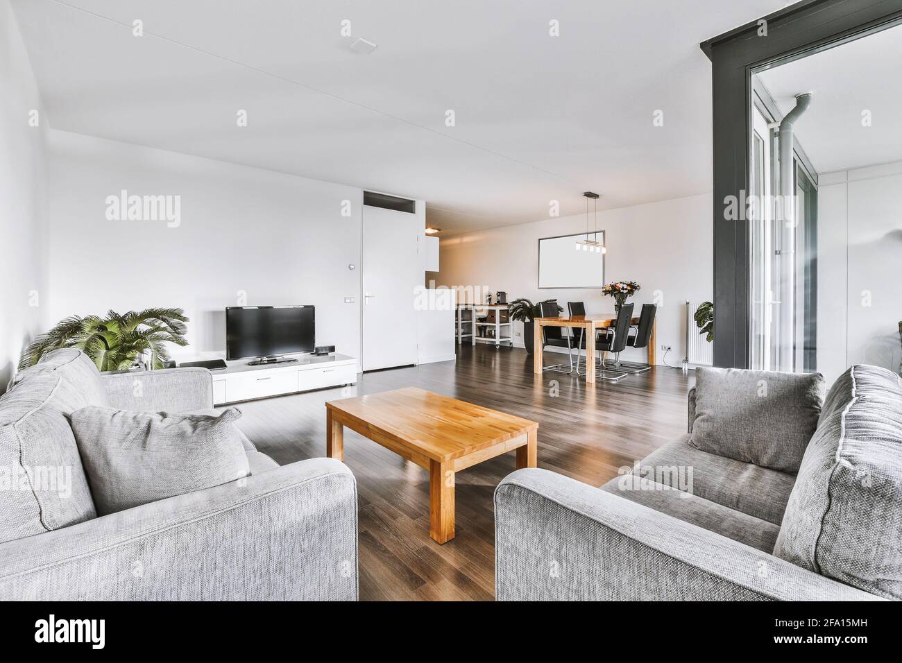Spacious modern room with lounge and dining areas Stock Photo - Alamy