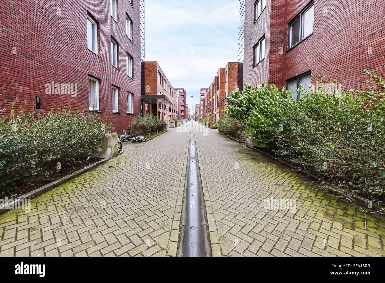 Straight path amidst apartment buildings Stock Photo - Alamy
