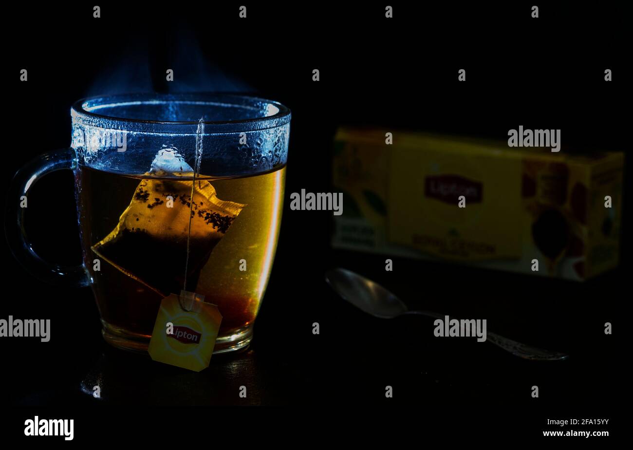 Lipton tea cup and cardboard packaging of tea on a black background ...