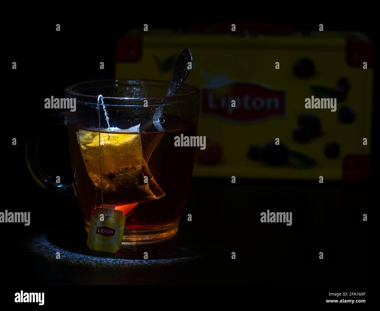 Lipton tea cup and tea metal packaging on black background Stock Photo ...
