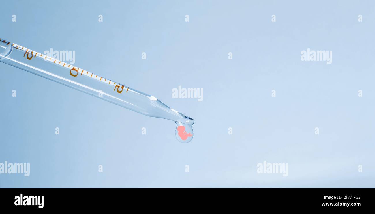 Medical laboratory. A test tube with a human embryo on a blue ...