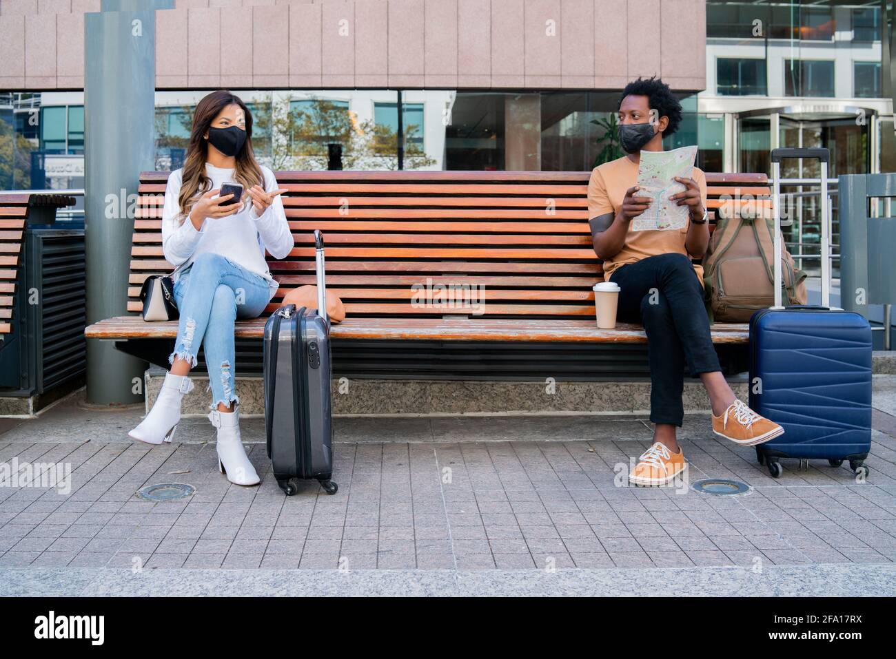 Tourist people waiting outside airport or train station Stock Photo - Alamy