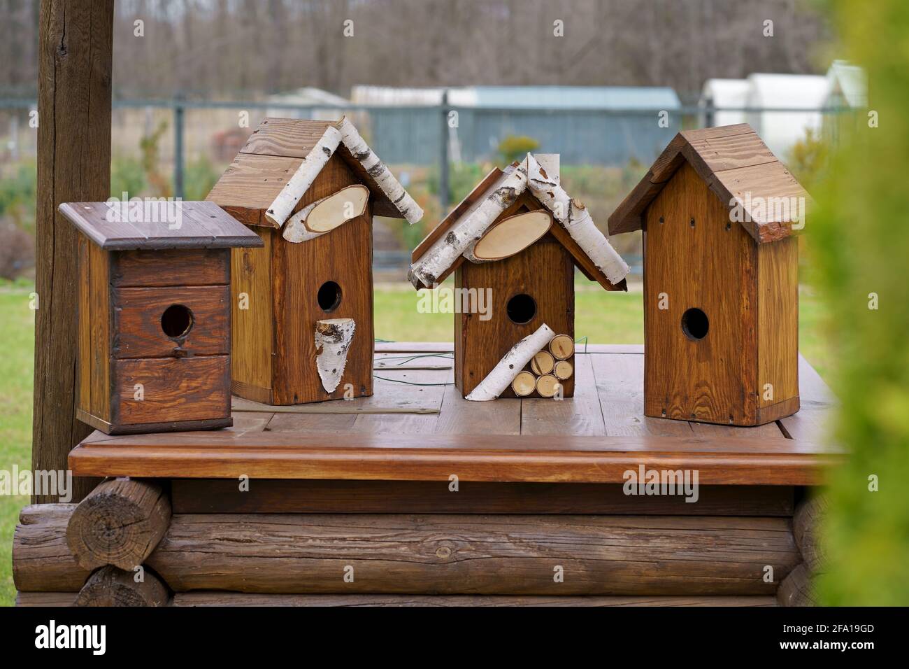 Craftsman making a wooden birdhouse with tools or equipment and wood ...