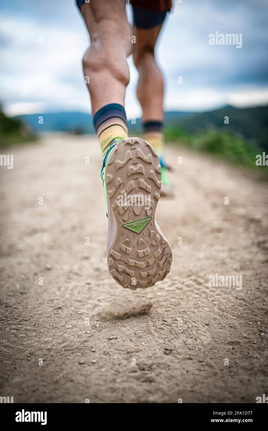 Boy running trail in a mountainous area of and full of trees Stock ...
