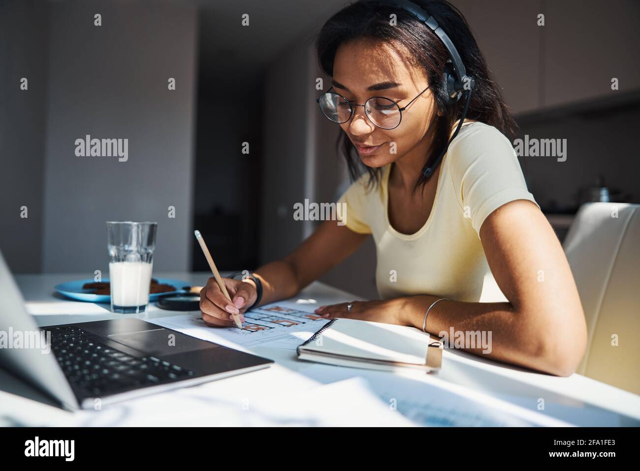 Beautiful young woman drawing architectural plan at home Stock Photo ...