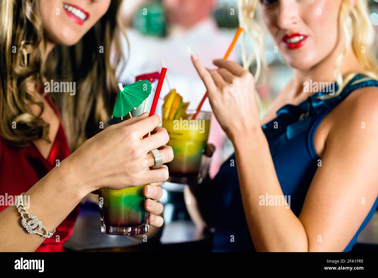 Young women with cocktails in bar or club Stock Photo - Alamy