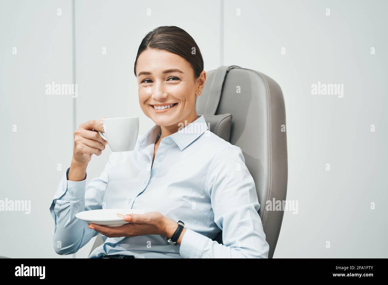 Happy client sitting in the beauty salon armchair Stock Photo - Alamy
