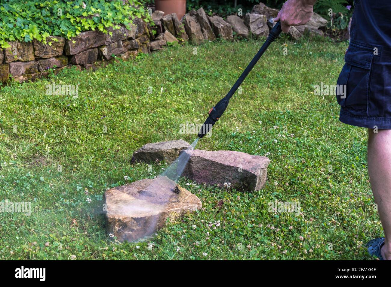 Man cleans two old sandstones with a high-pressure cleaner Stock Photo ...